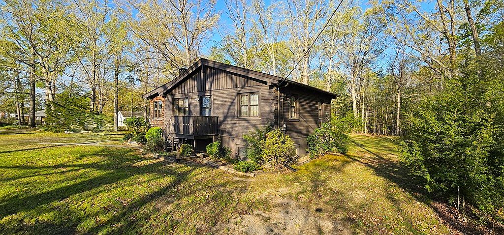 1979 log cabin in Skipwith, Virginia, featuring expansive wood ...