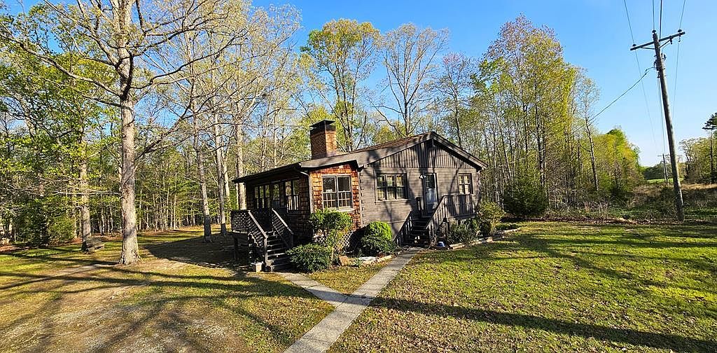 1979 log cabin in Skipwith, Virginia, featuring expansive wood ...