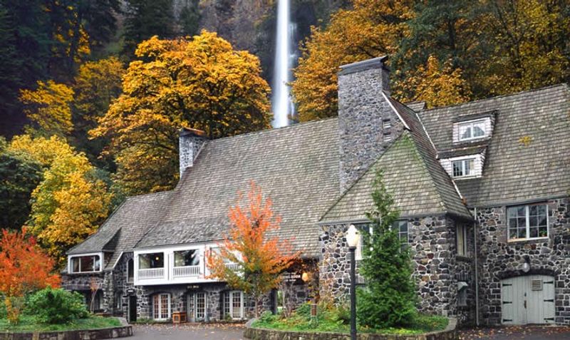 This historic Oregon lodge at the base of a towering waterfall just ...