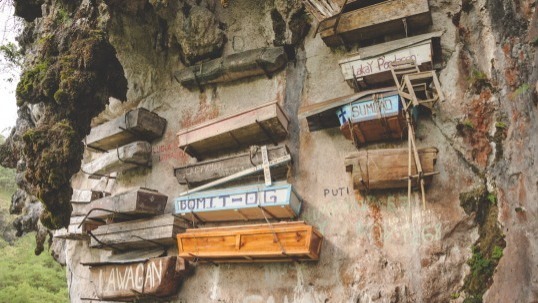 The story behind coffins dangling from cliffs