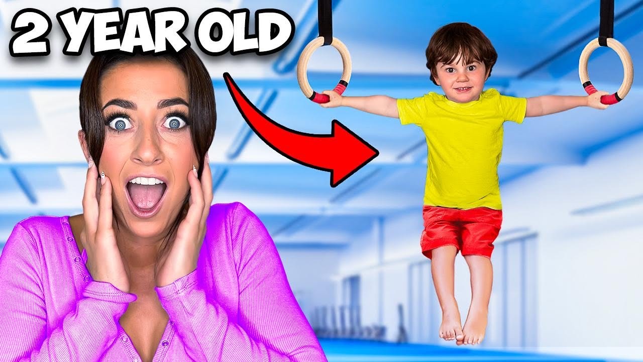 Acrobat trains a two year old to perform gymnastics skills