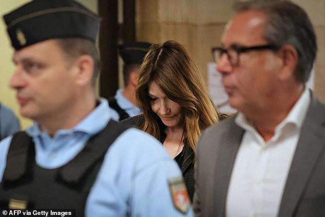 Carla Bruni looks far from her usual glamorous self as she supports ...