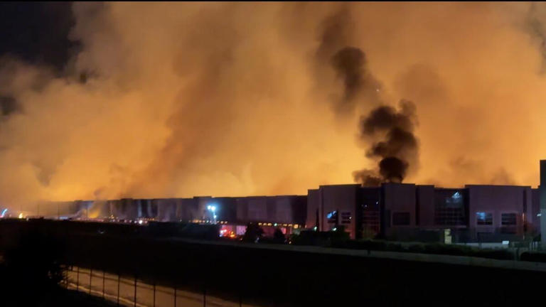 Arson suspect arrested after fire engulfs major company's warehouse