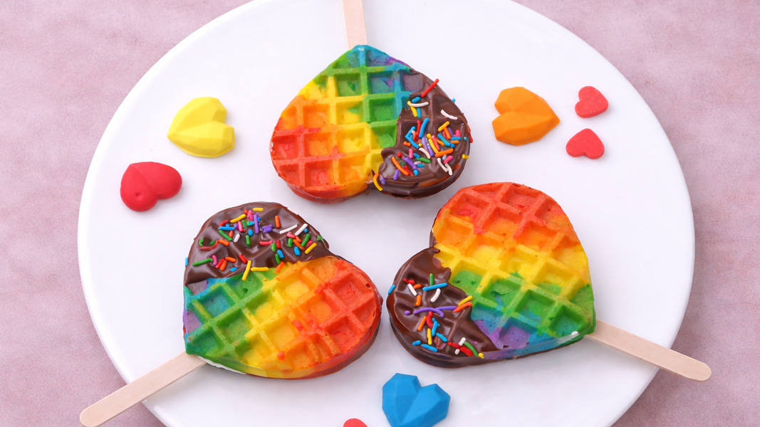 Rainbow heart waffle dessert with chocolate topping
