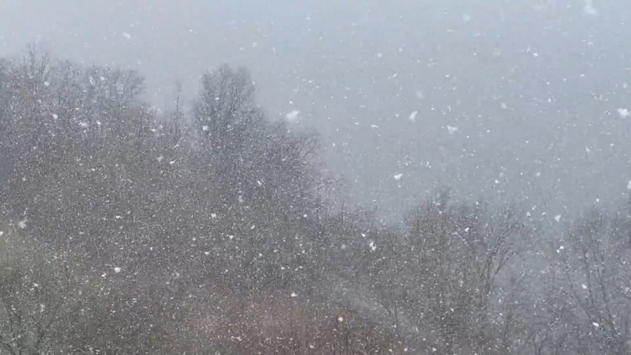 Spring snowfall blankets Fresh Pond in Cambridge, Massachusetts, USA