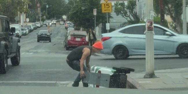 Man helps fallen delivery robot