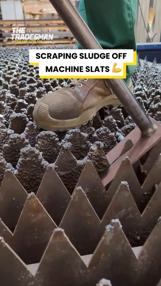 Scraping sludge off machine slats