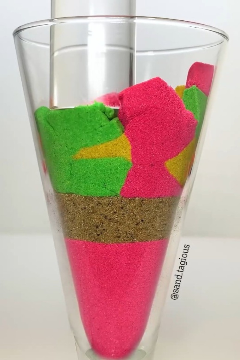 Layered kinetic sand blocks pressed in glass