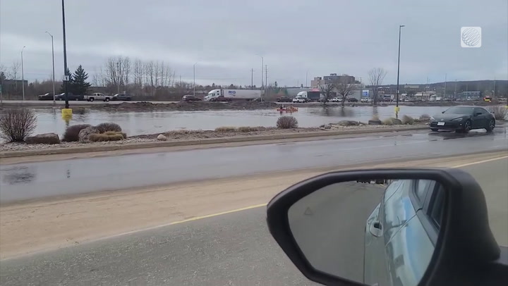 Canoeing in a flooded Walmart parking lot