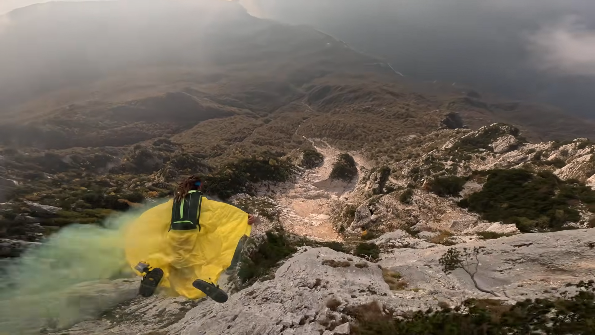 Watch these two men jump off a mountain ridge