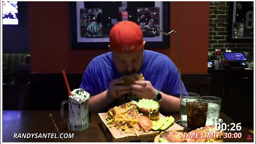 Man attempts $125 burger challenge with four stacked burgers, fries and ...