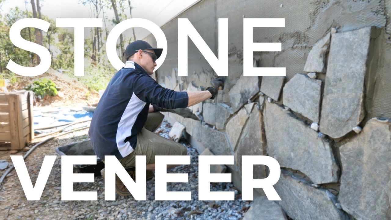 Homeowners apply natural stone veneer during exterior home build phase