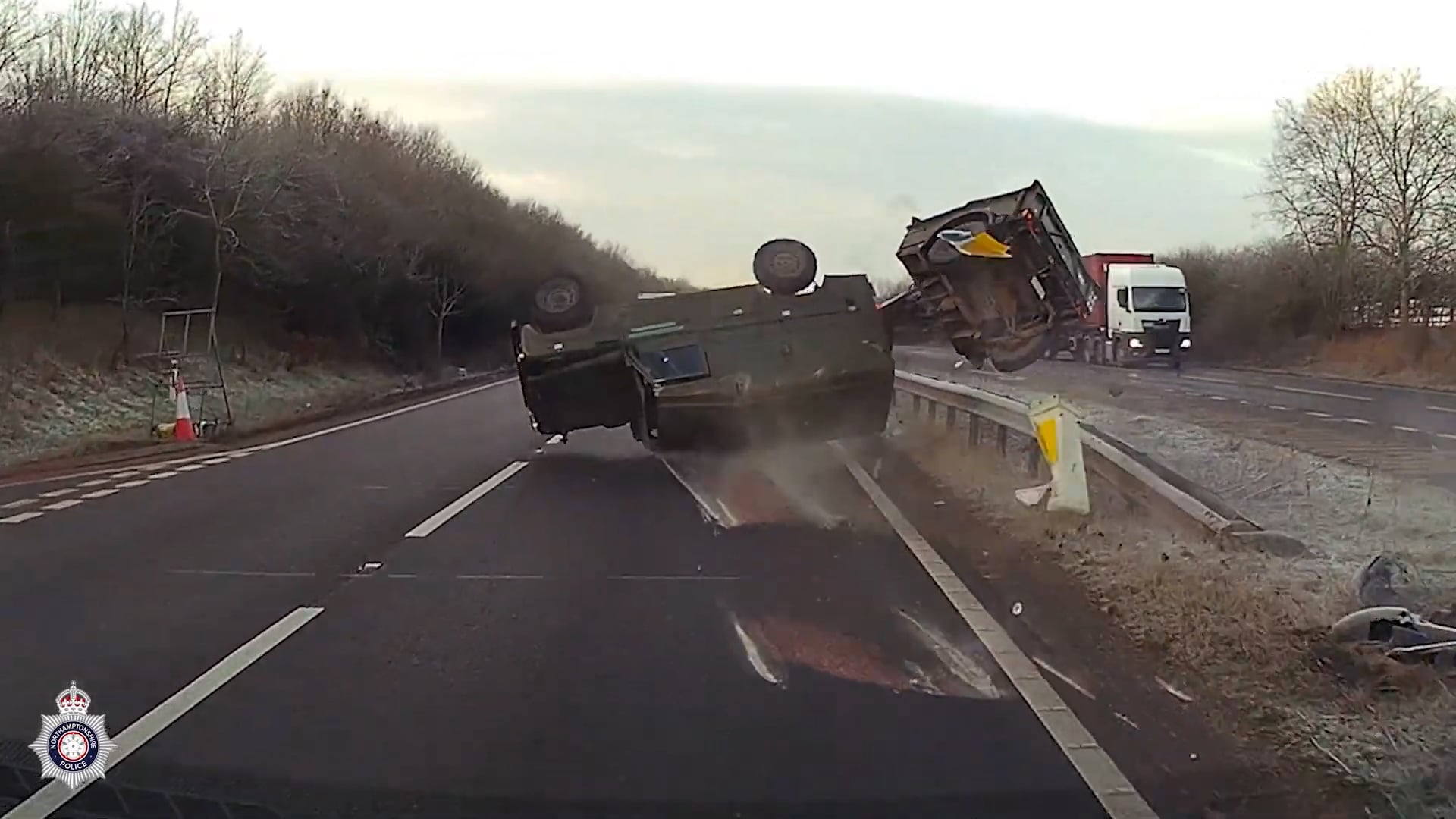 Horror moment military vehicle crashes and flips after being cut up by ...