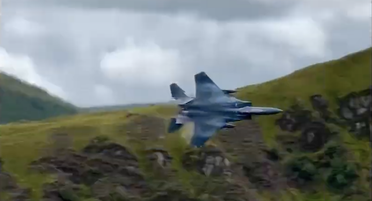 Warplane flies dangerously low over ground