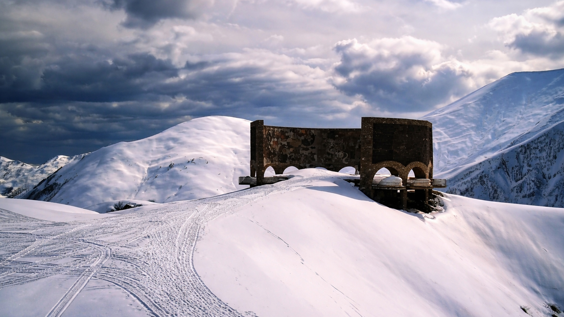 Dramatic winter scene with historic building in mountains