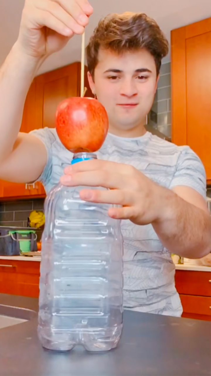 Reverse video magic: The apple in bottle prank revealed step by step