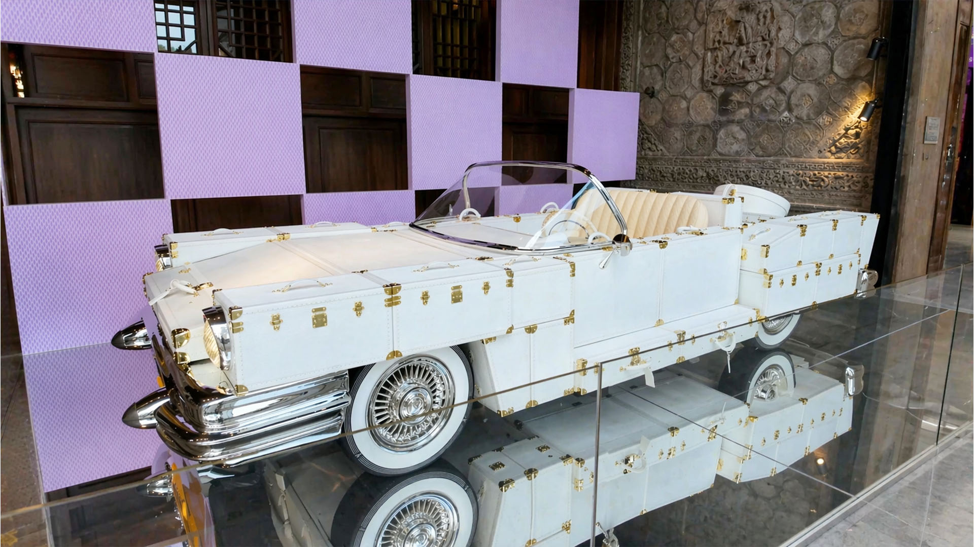 A car shaped display that blends automotive form with luggage design