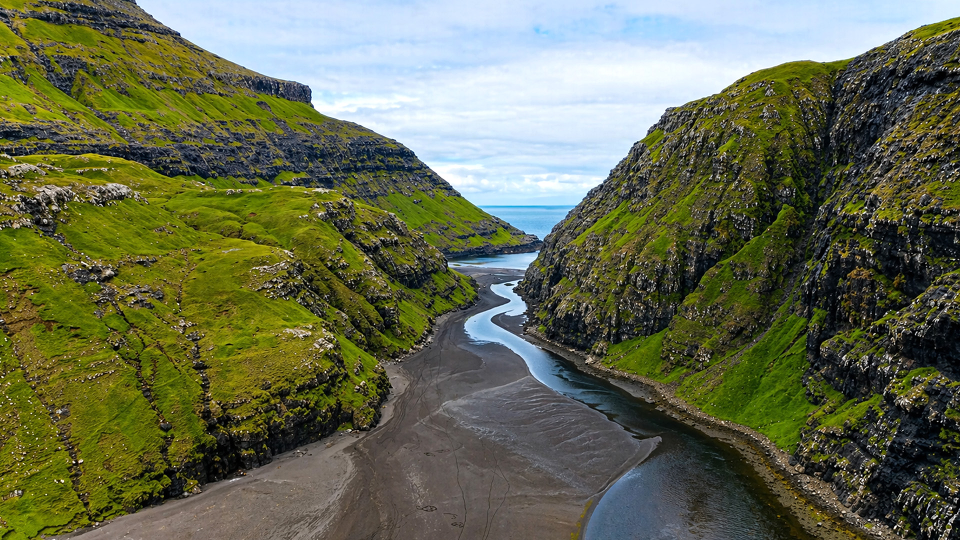 A deep valley with a river cutting through steep cliffs