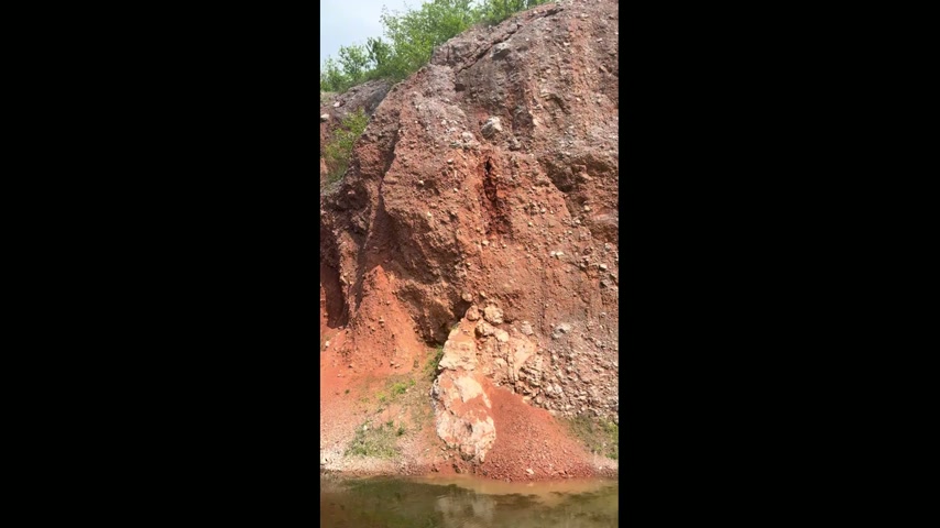 Large rock overhang collapses into lake from cliffside in Jiangsu, China