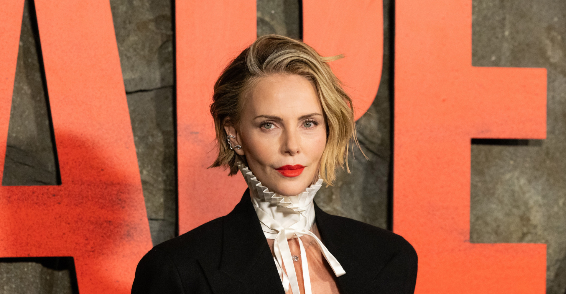 Charlize Theron goes shirtless in daring open blazer at Netflix's 'Apex ...
