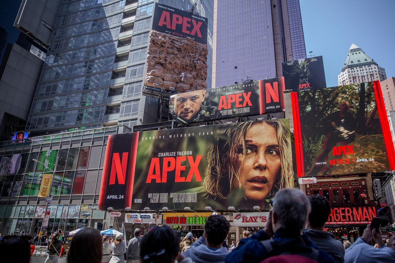 Charlize Theron scales a billboard in Times Square after learning how ...