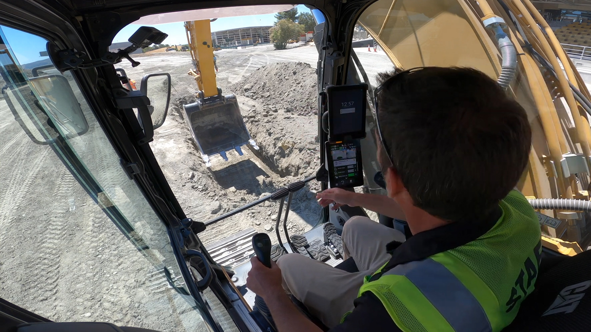 Massive excavator POV operator digging with precision