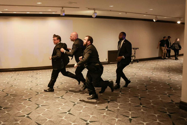Photos capture guns drawn and guests diving under tables as pandemonium ...