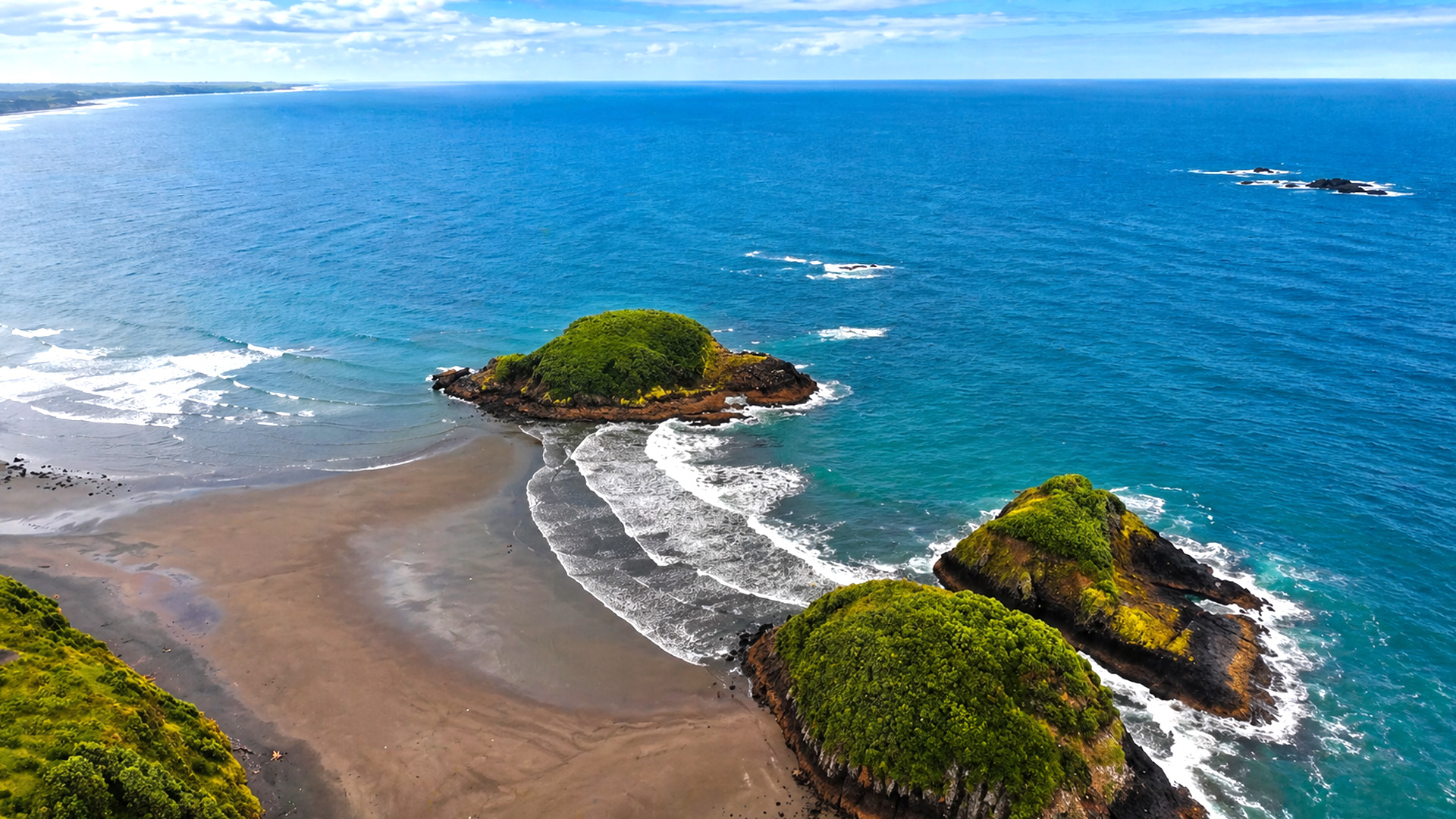 A cluster of rock islands standing alone in the ocean