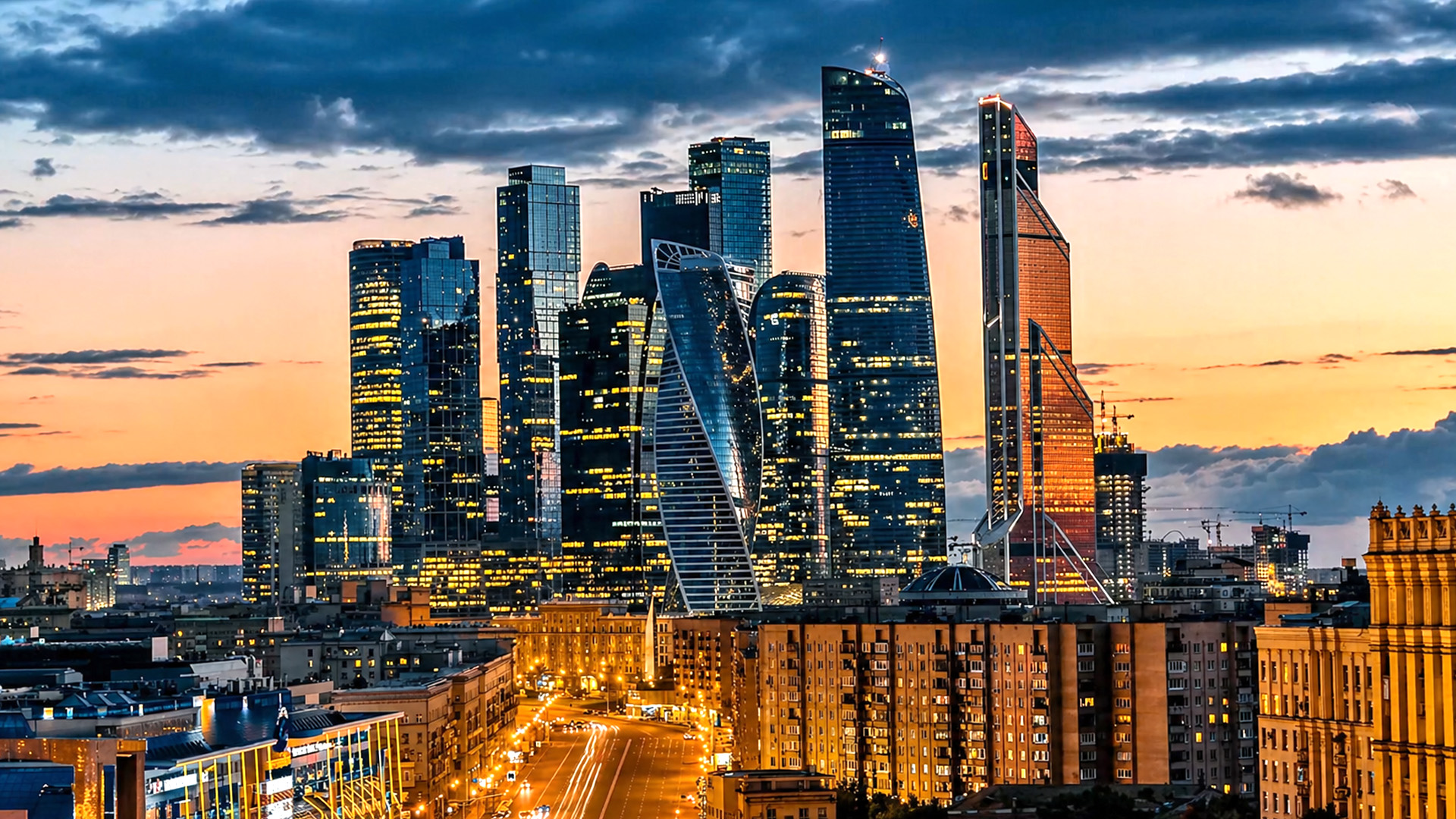 A modern skyline glowing under a golden sunset