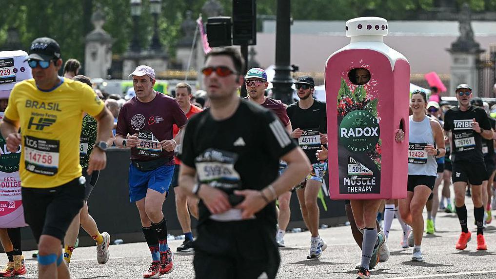 Record breakers and finish line proposals: London Marathon in pictures