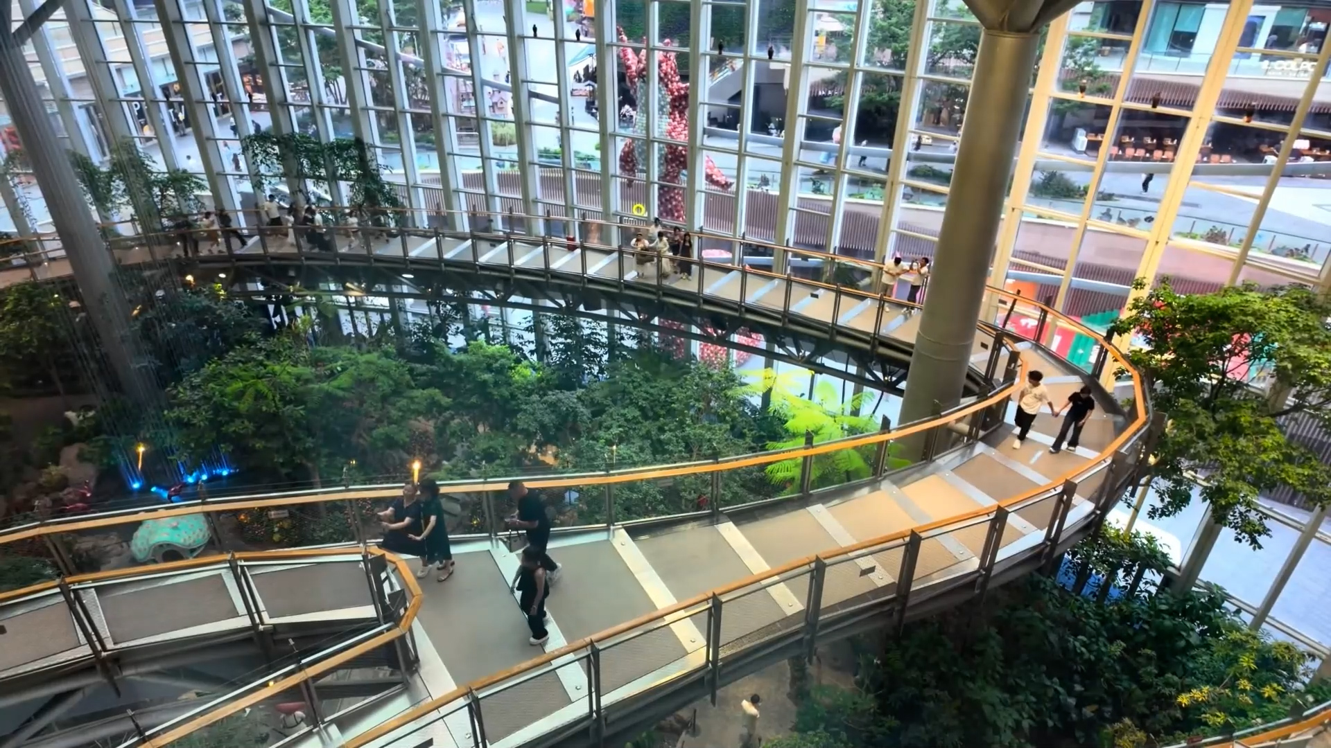A multi level mall view centered around a lush indoor garden