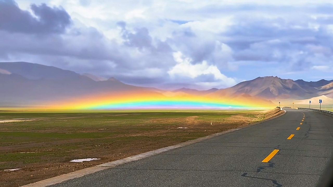 Extremely rare ground-hugging rainbow appears near mountain range in Tibet