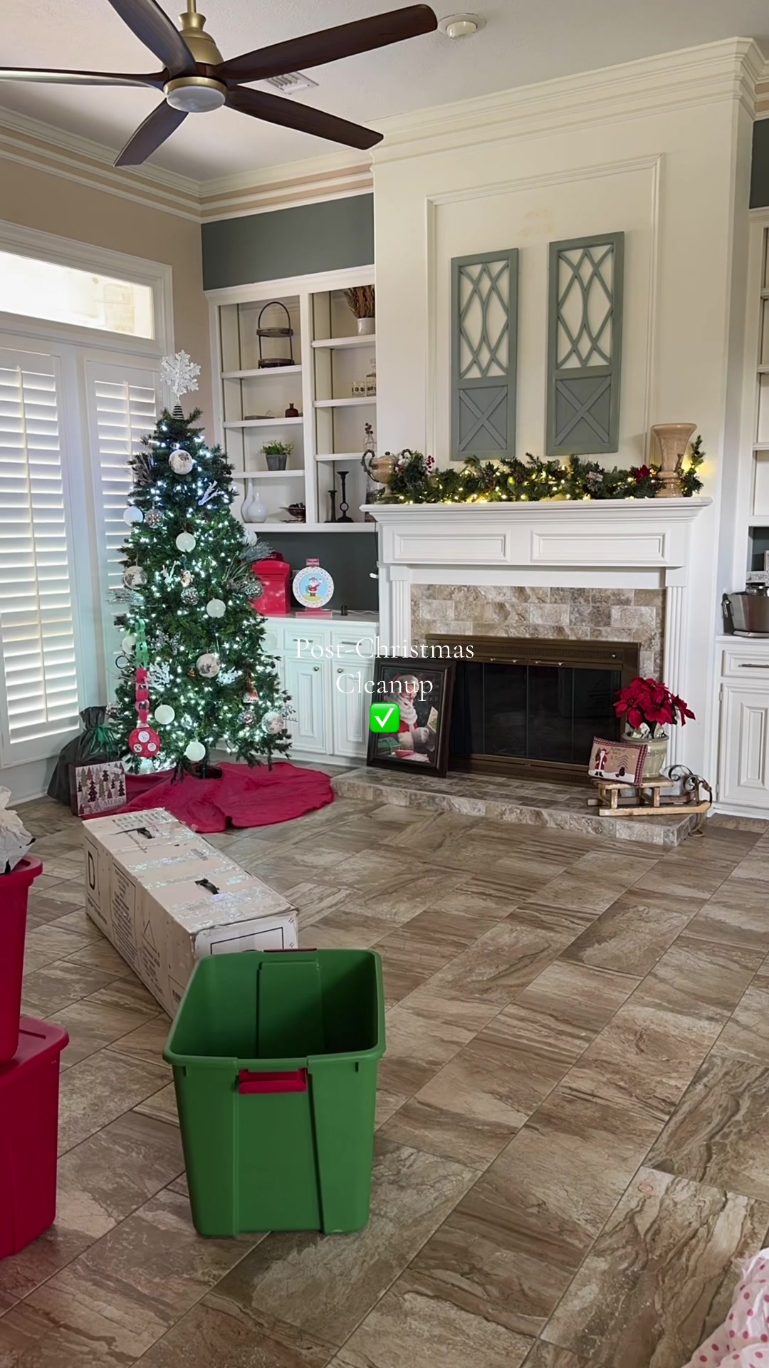 Post-Christmas cleanup taking down tree decorations, packing storage bins
