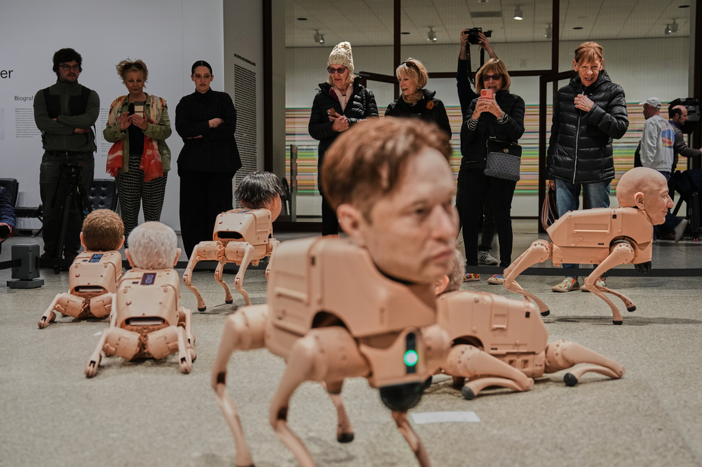 Robot dogs with Musk and Zuckerberg heads roam around Berlin gallery in ...