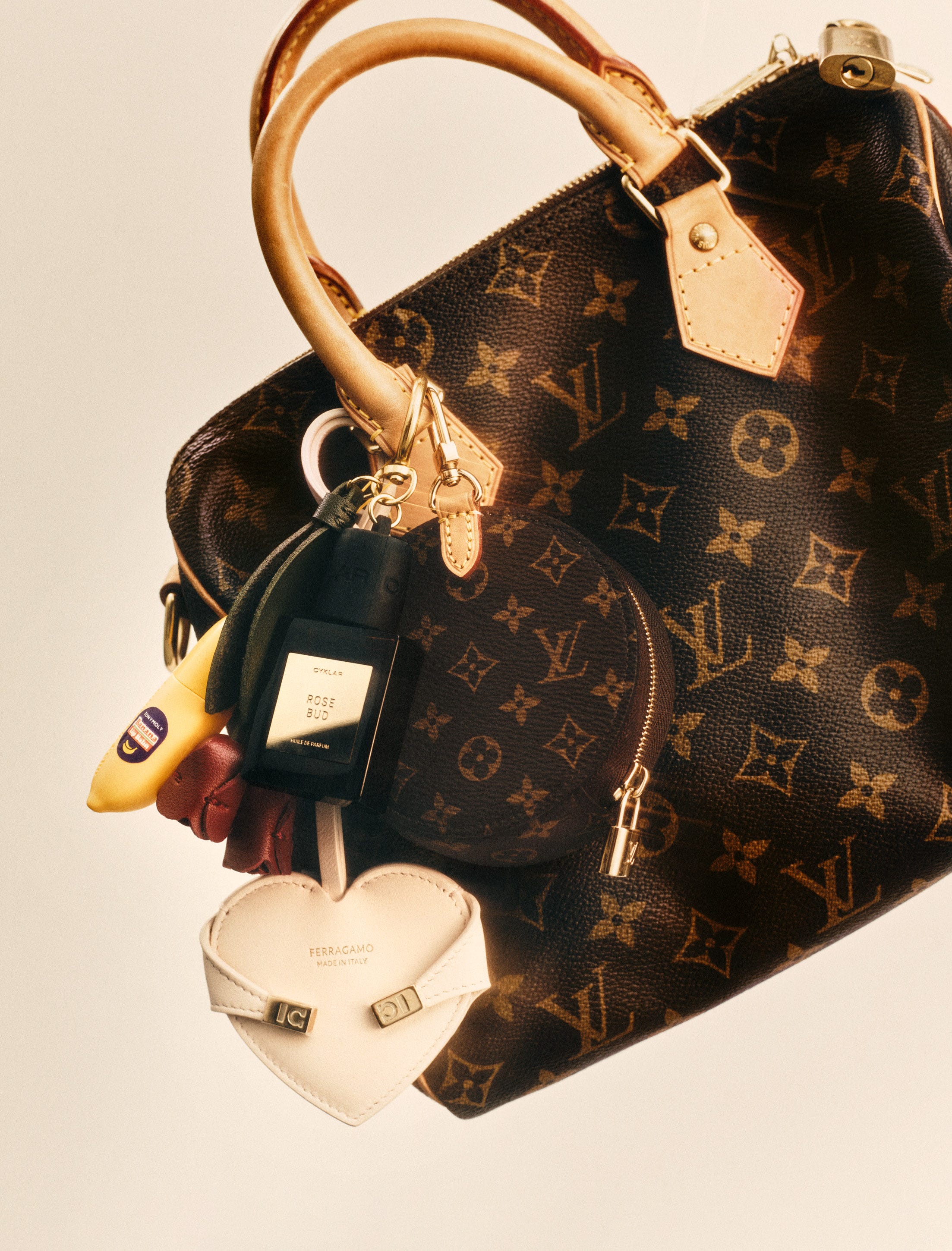 Beauty products as bag charms are trending for summer 2026