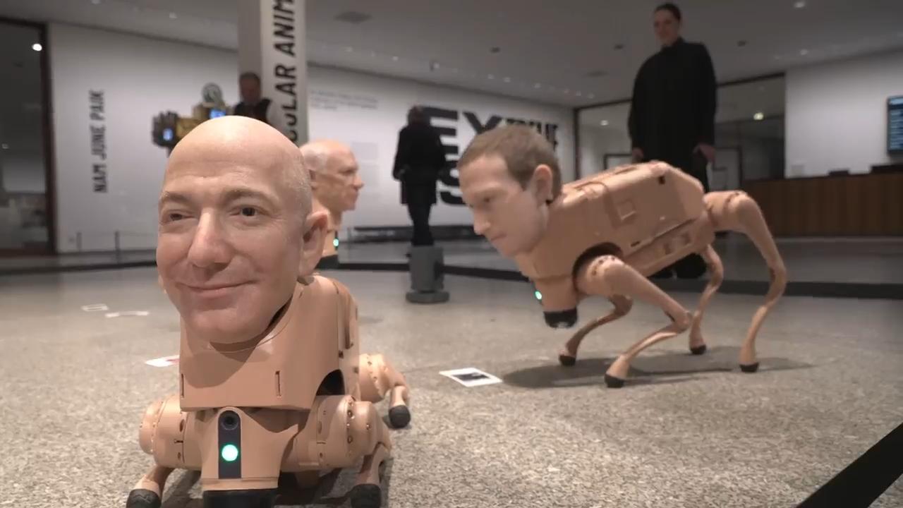 Robot dogs with Musk and Zuckerberg heads roam around Berlin museum in ...