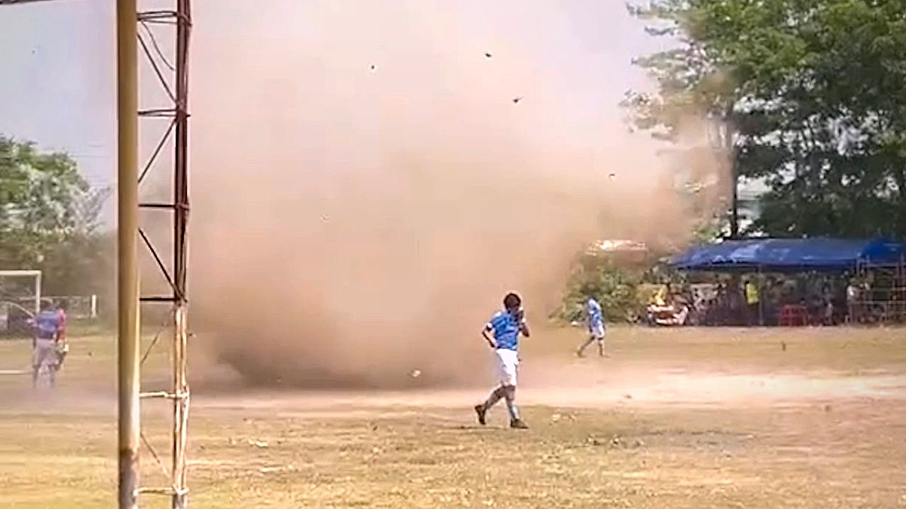Dust devil tornado spins across football pitch mid-match