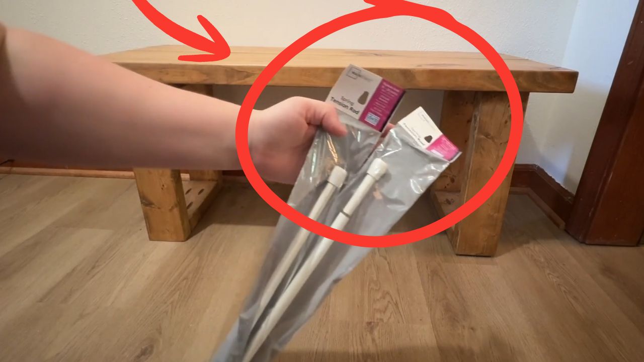 Stick a Walmart tension rod under a bench (this is genius!)
