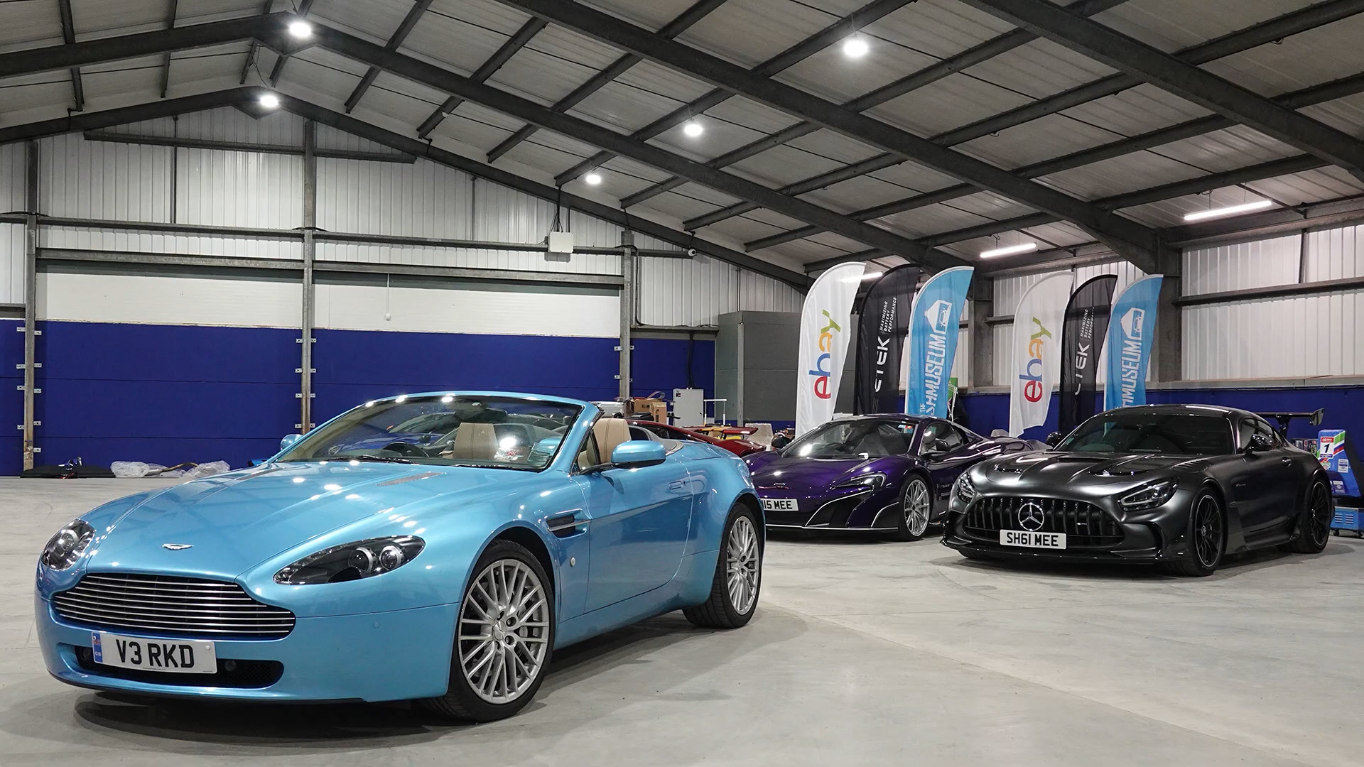 Luxury car collection featuring Aston Martin and Mercedes AMG
