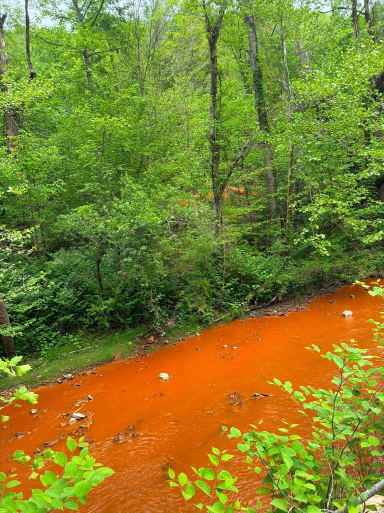 Several agencies investigating orange-colored creek