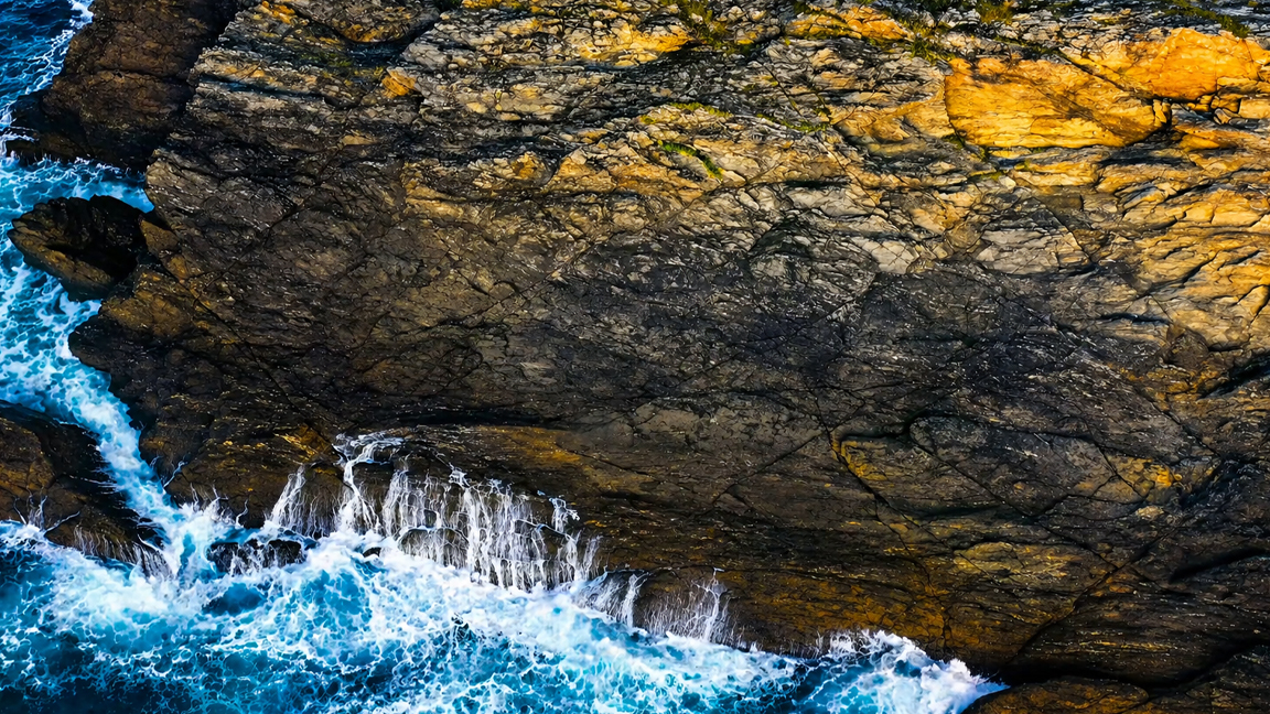 Dramatic seascape with blue water and textured rock formation