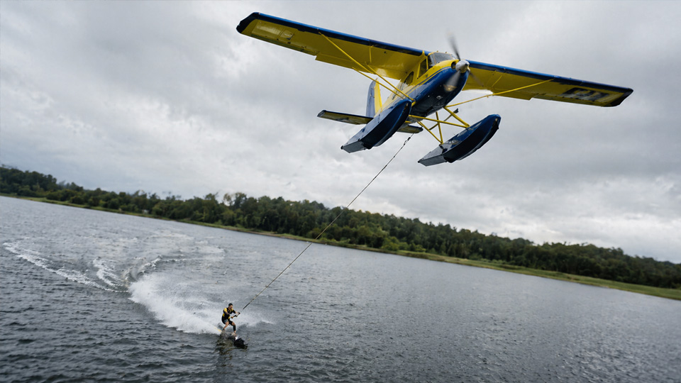 Barefoot ski scene shows airplane tow action