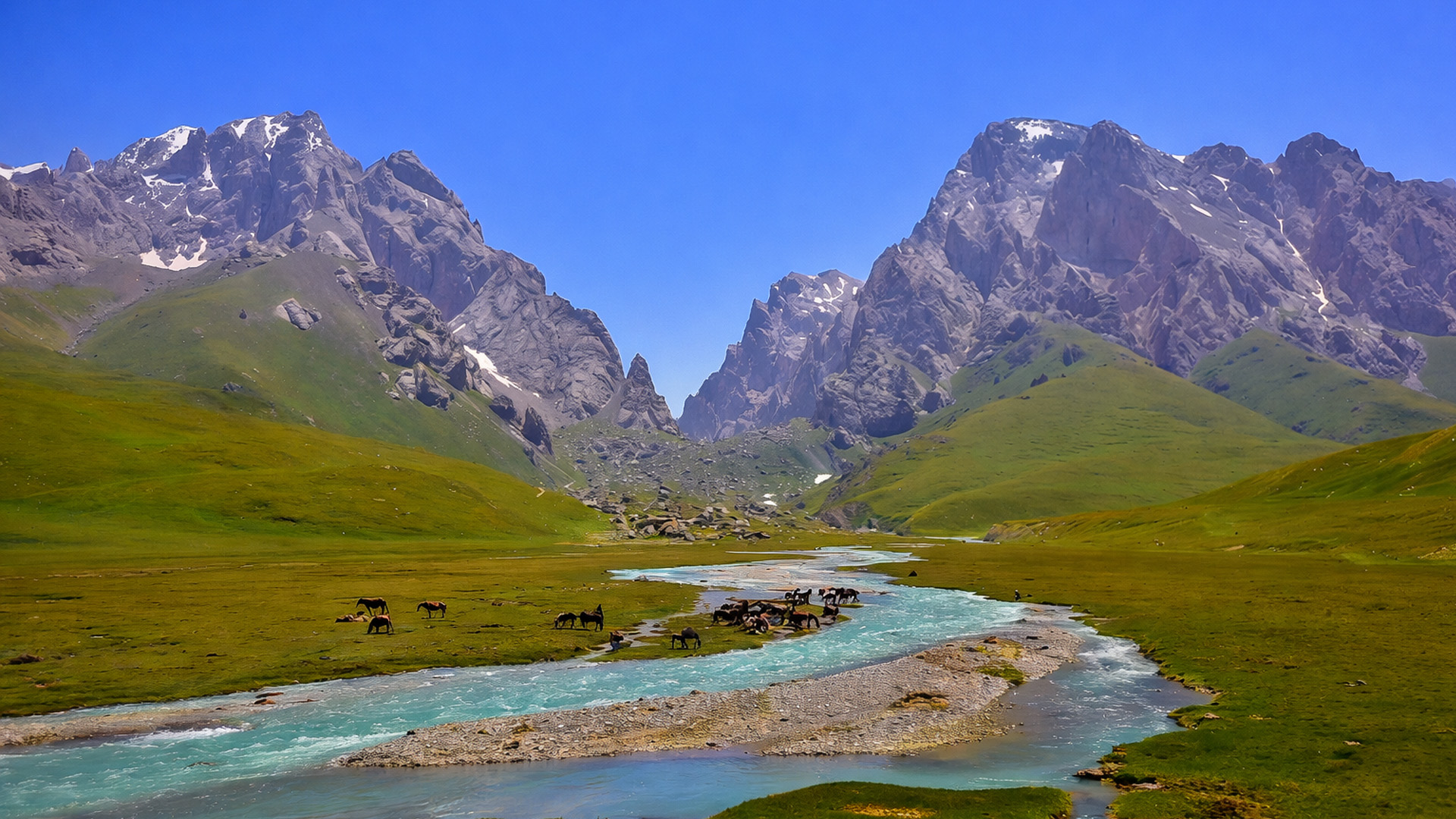 A bright turquoise river cutting through alpine mountains