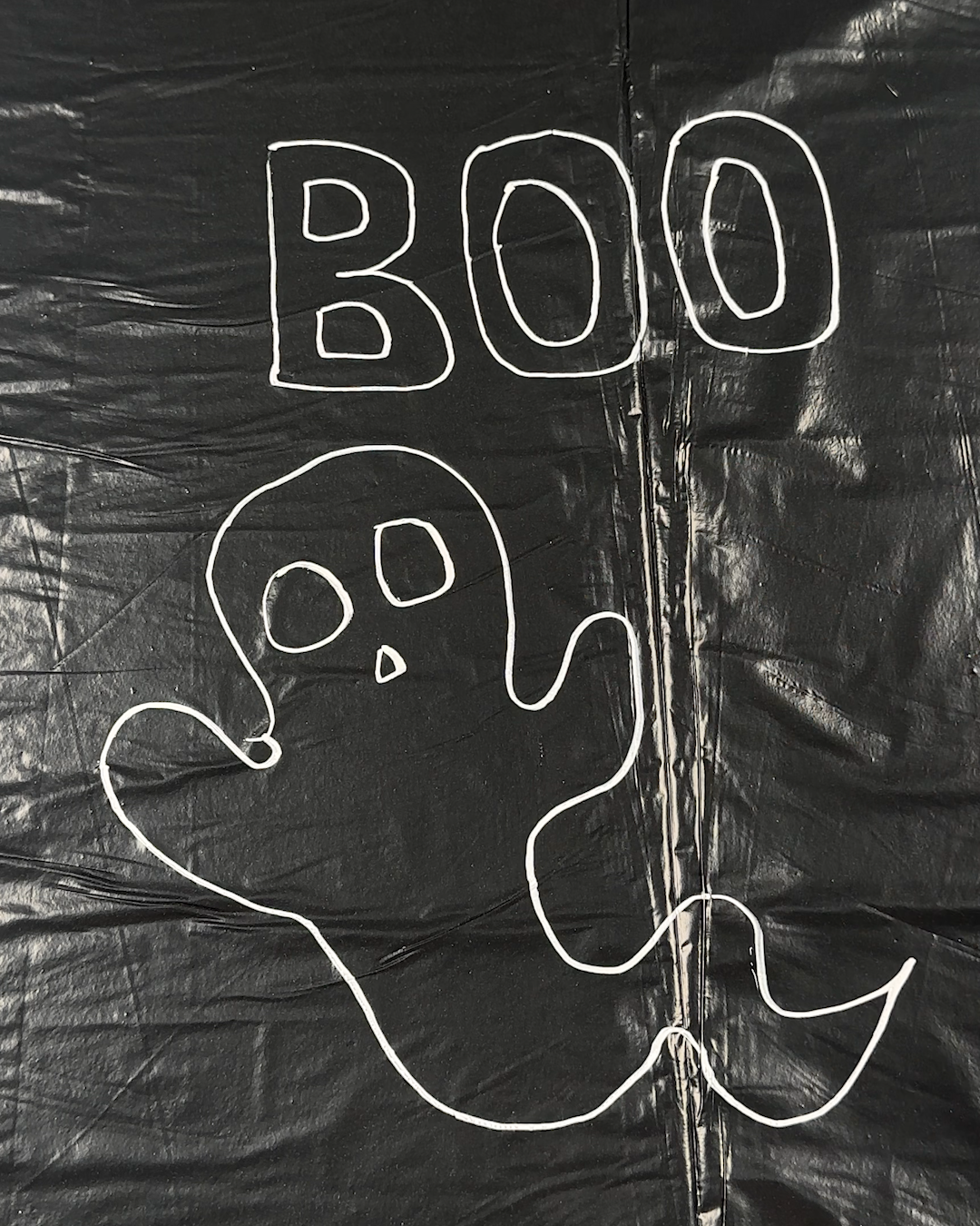 Spooky window decor made from trash bags👻