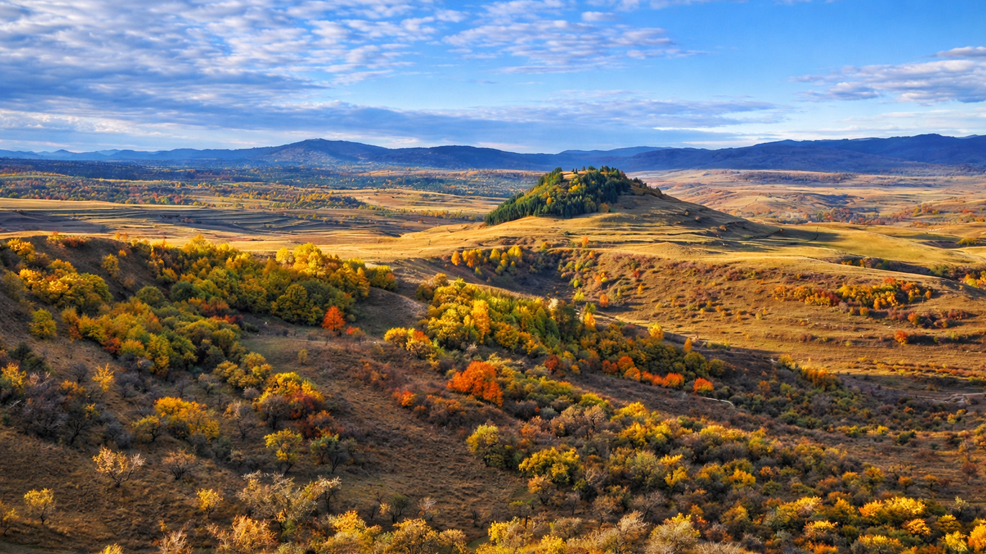 A quiet Transylvanian countryside covered in autumn colors