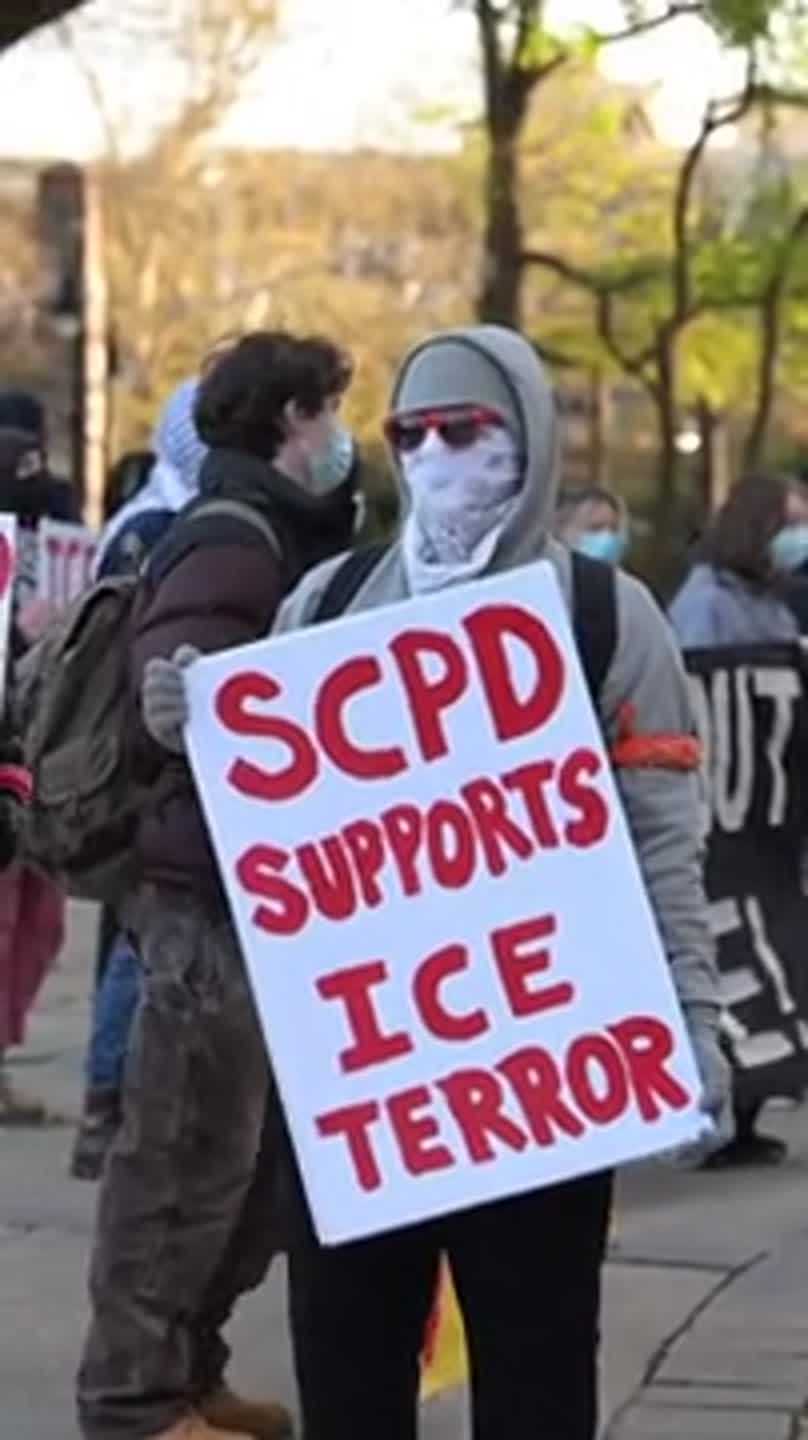 ICE protestors hang signs at State College Municipal Building