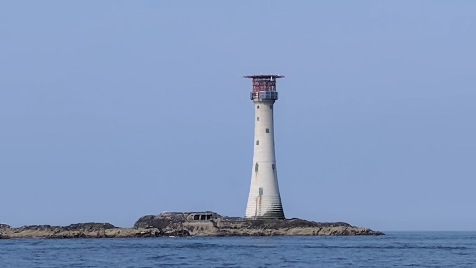 Watch a wave dwarf this 72-foot lighthouse - then the keepers are trapped