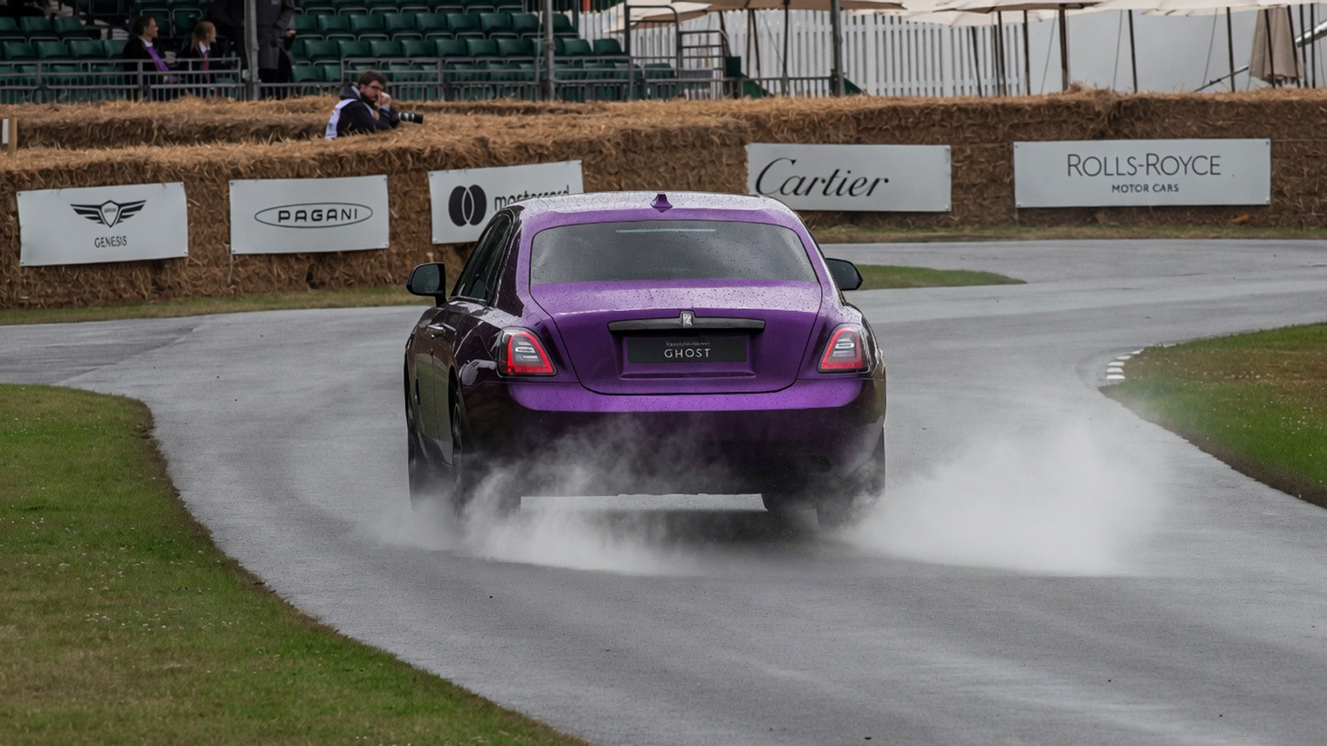 Purple Rolls Royce Ghost sliding on rainy track
