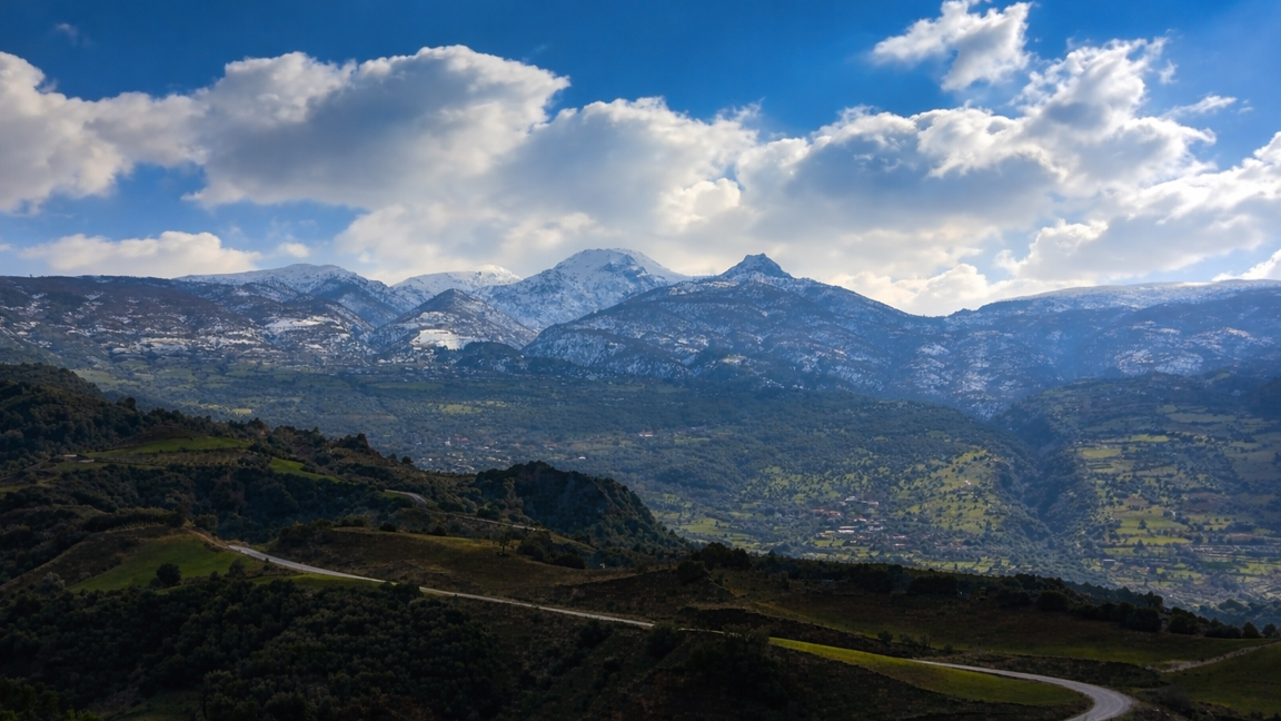 Wide valley view beneath a mountain range