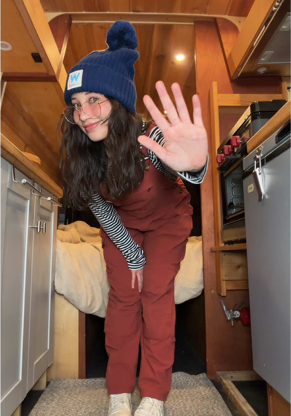 Cozy moment in blue beanie and red overalls expressing feelings